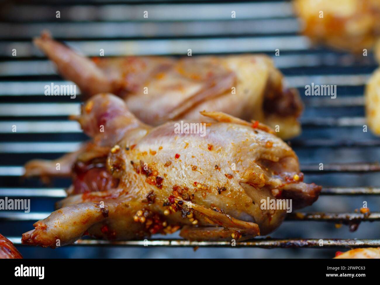 Preparation of marinated quail on the grill grate Stock Photo - Alamy