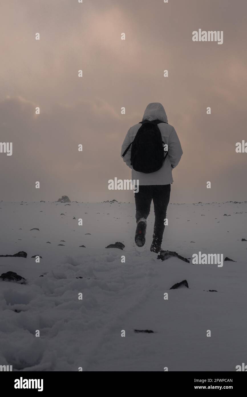 young boy in white jacket and backpack in snow Stock Photo - Alamy