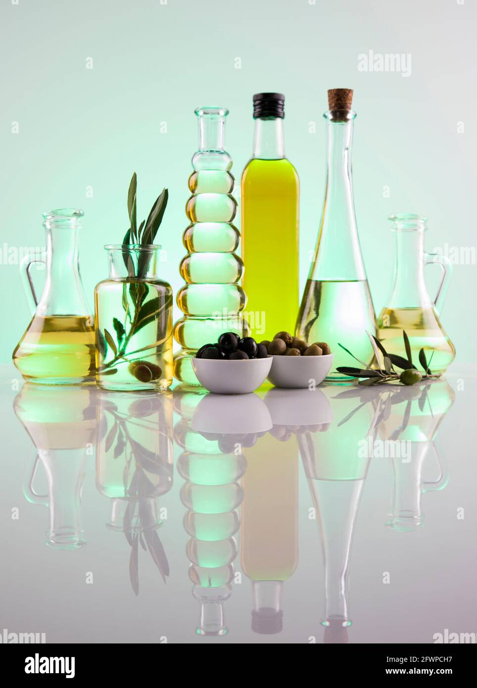 Olive oil bottles, olive branch and Cooking oils Stock Photo - Alamy