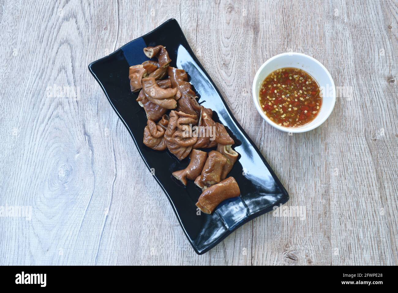 grilled slice pork intestine on plate dipping spicy sauce Stock Photo ...