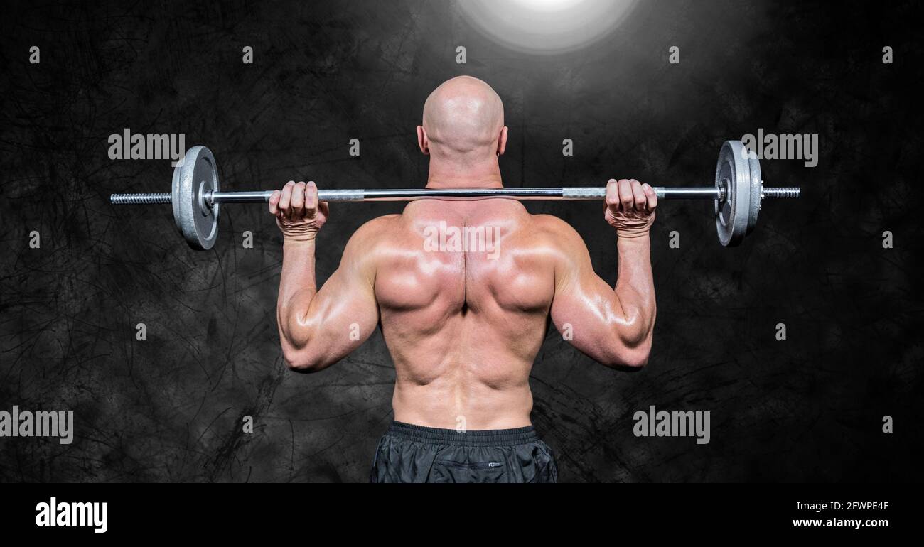 Composition of rear view of muscular man lifting weights with glowing ...