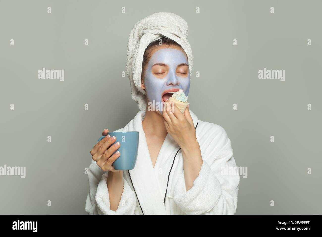Female routine and breakfast. Young cute woman in cosmetic face mask ...