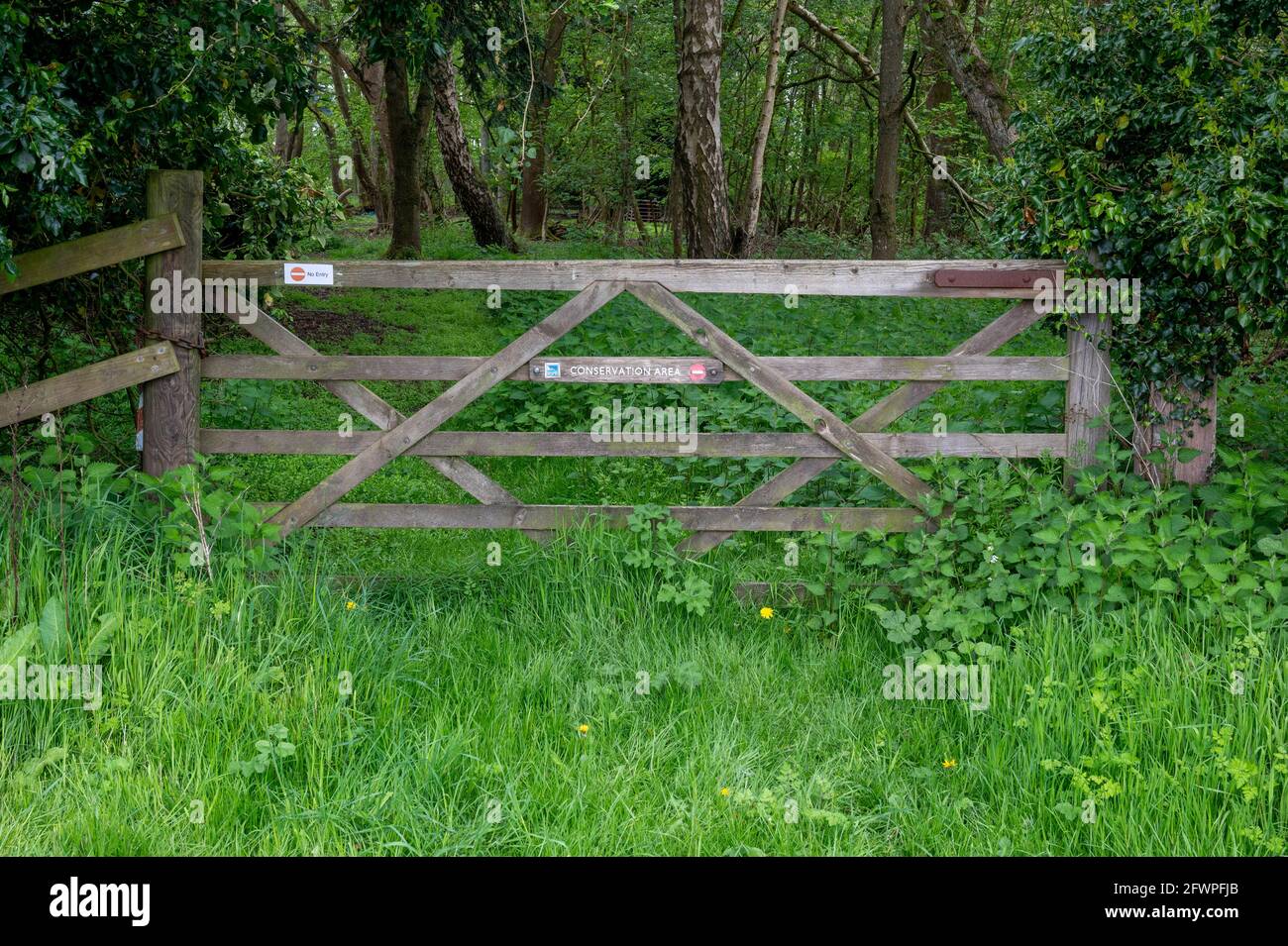 Wooden four bar gate with keep out sign and conservation area sign in ...