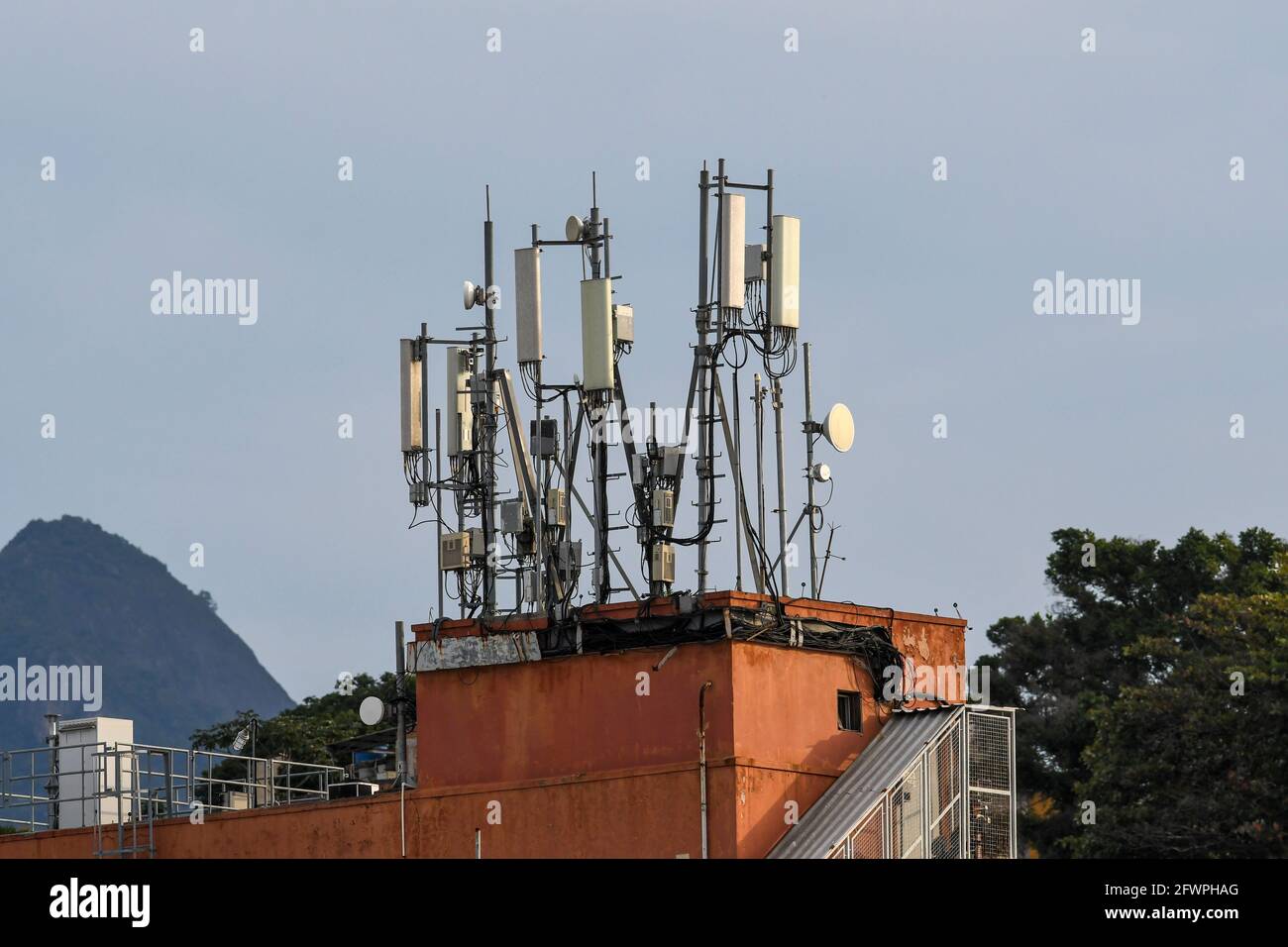 Cellular transmitters on top of building with a blue sky Stock Photo ...