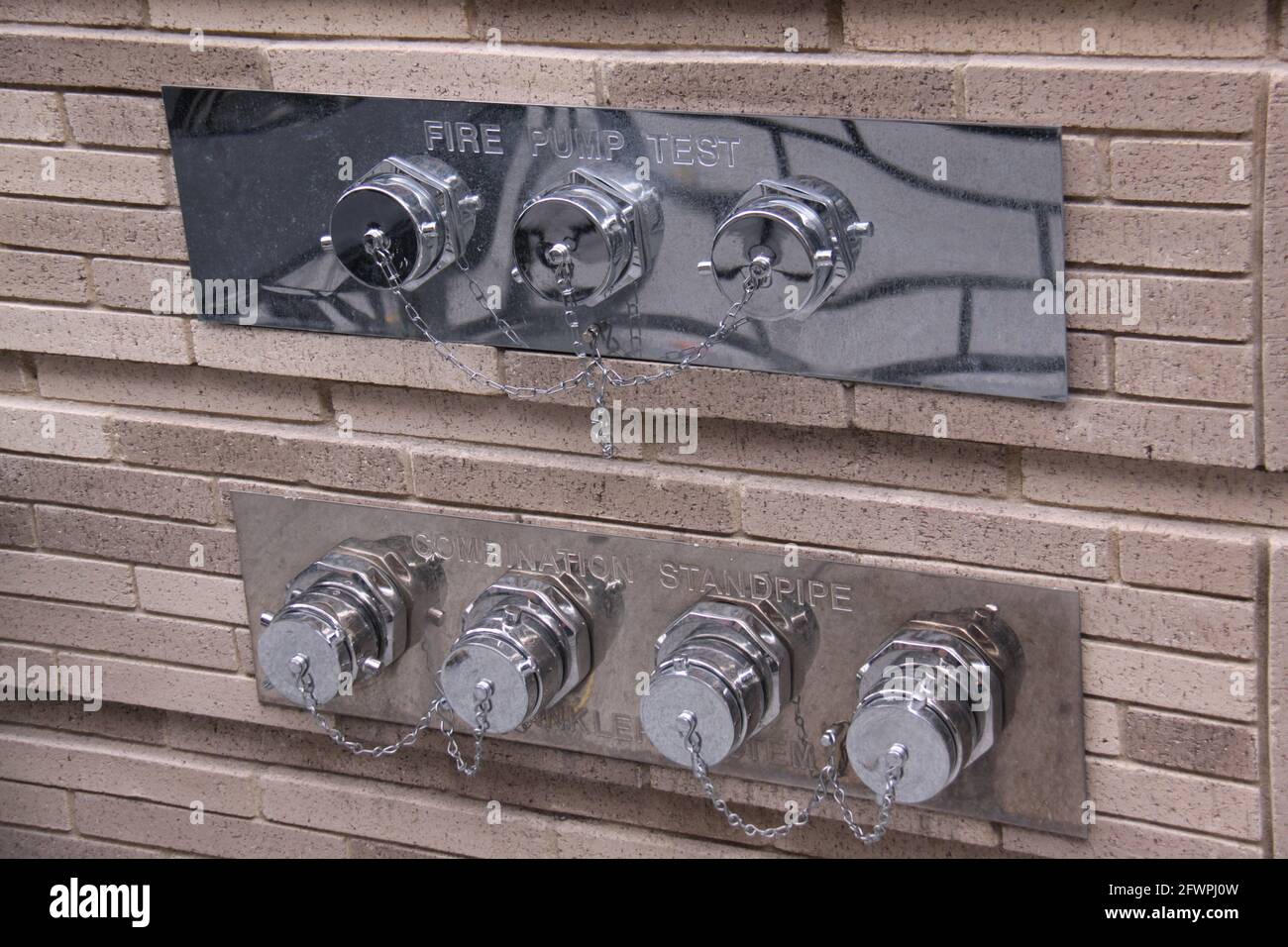 shiny new fire hydrants on a grey brick wall Stock Photo - Alamy