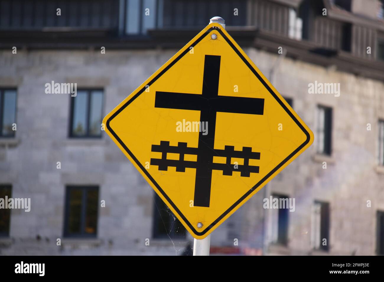 yellow and black diamond shaped warning sign cautioning for a railroad ...