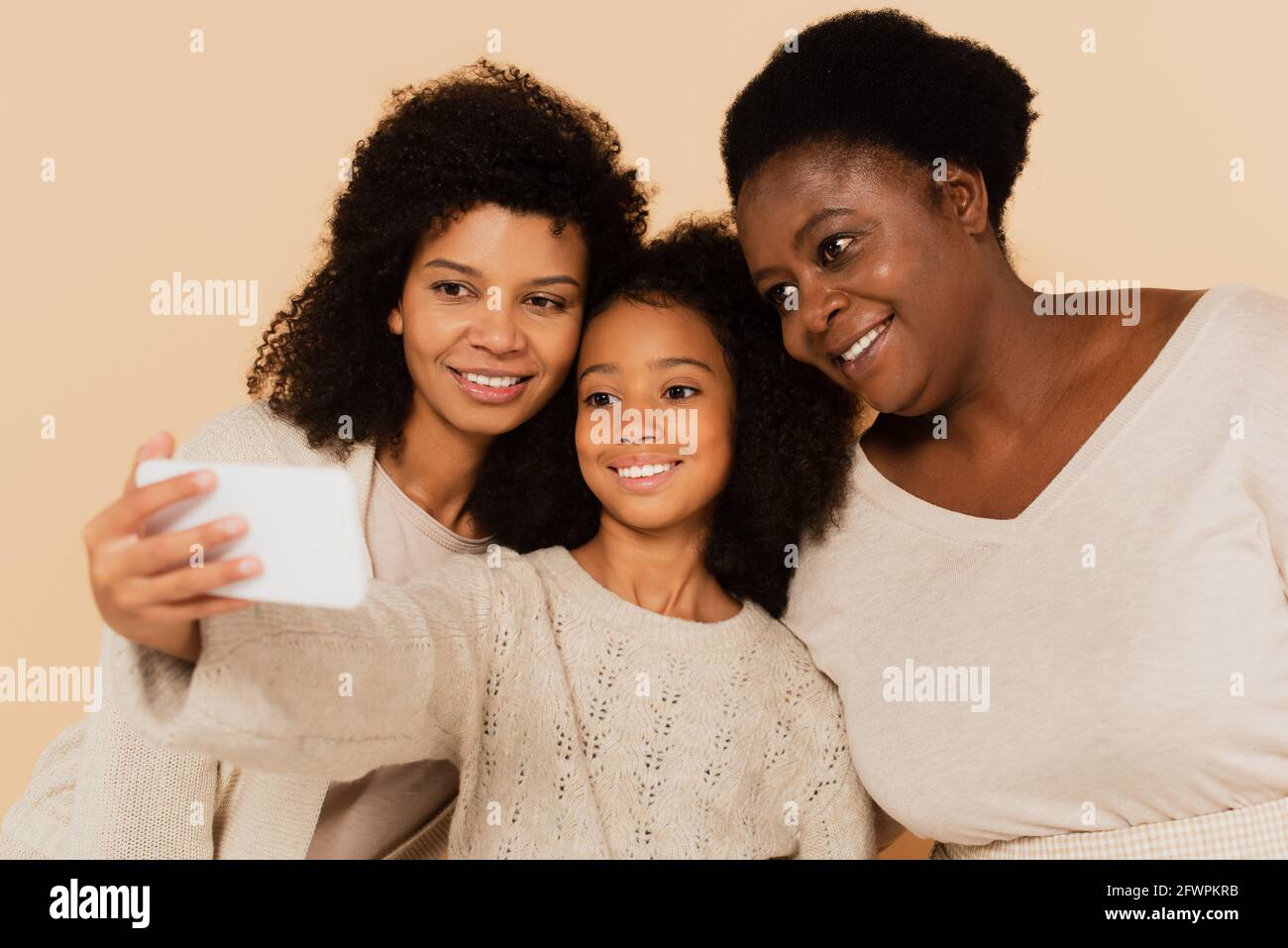 smiling african american daughter, granddaughter and grandmother taking ...