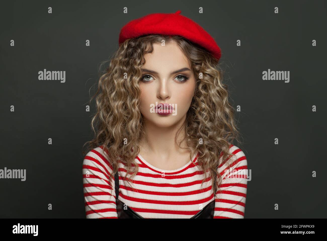 Portrait of nice french model woman with curly hair in red beret on ...