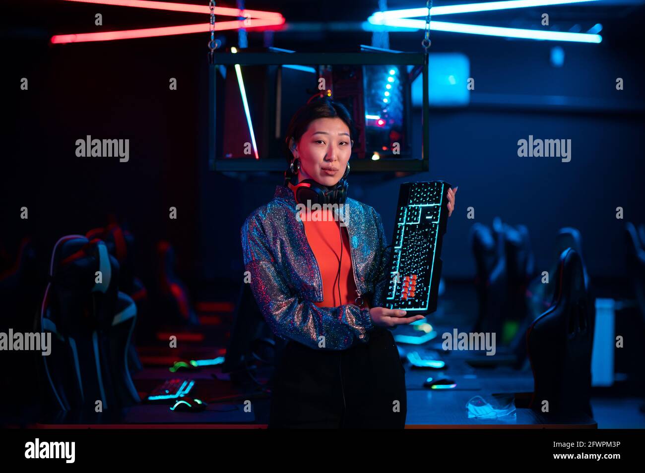 An experienced asian gamer shows a gaming keyboard and talks about its ...