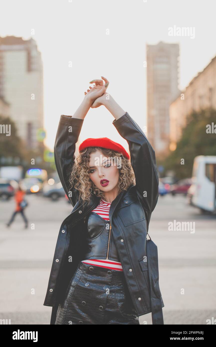 Fashion model woman with red lips makeup and curly hairstyle posing on ...