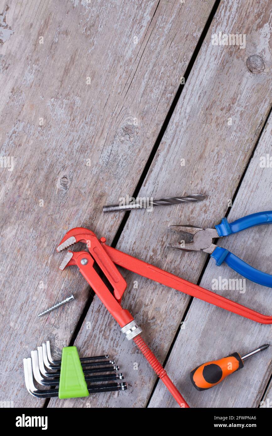 Rustic wooden background with different hardware tools Stock Photo - Alamy