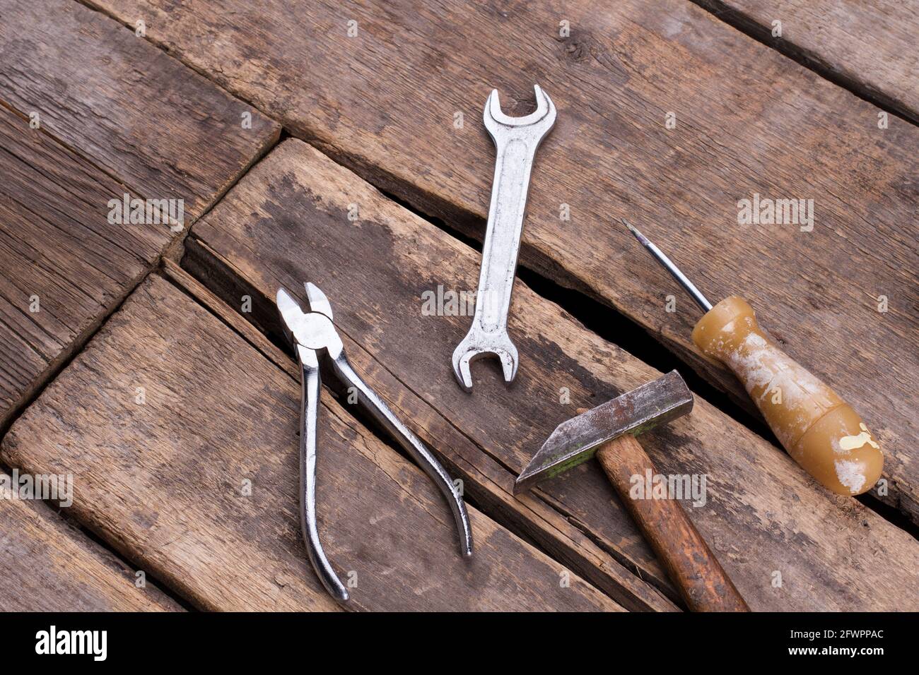 Used construction tools on old wooden boards Stock Photo - Alamy