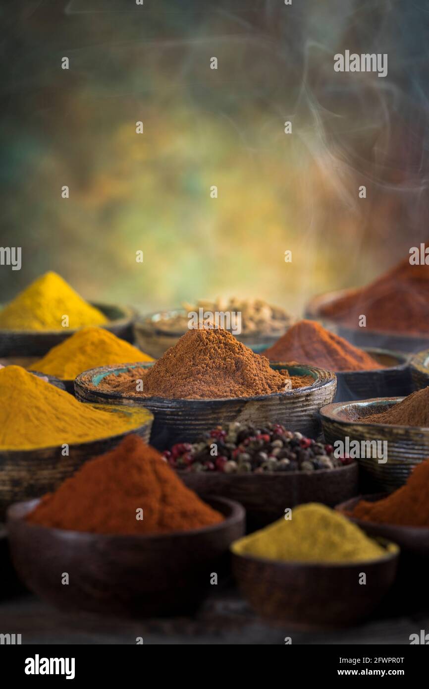 Assorted Spices and wooden bowl of smoke Stock Photo - Alamy