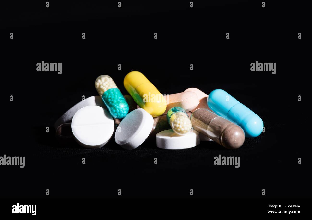 Heap of assorted pharmaceutical medicine pills in tablets and capsules ...
