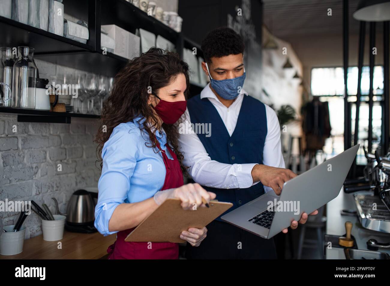 Coffee shop manager discussing issues with waitress in cafe, small ...