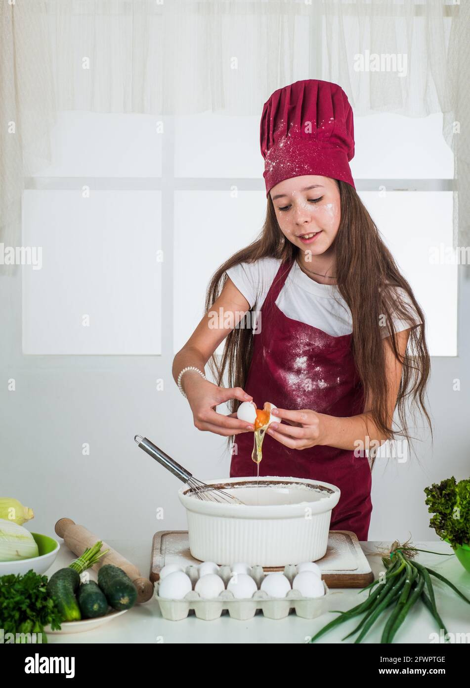 child girl cooking meal from healthy and organic products only ...