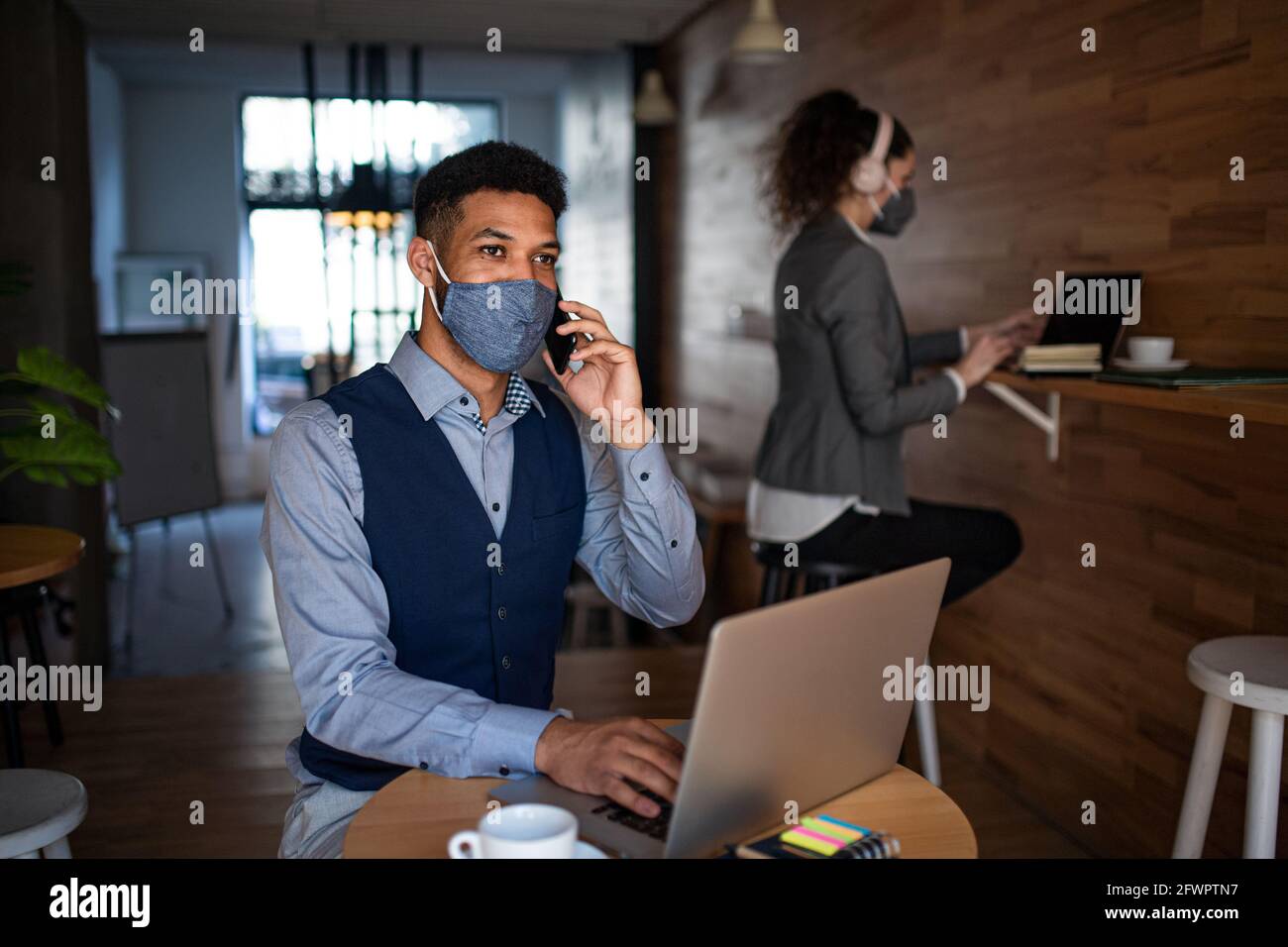 Business people with laptop working in cafe, small business ...