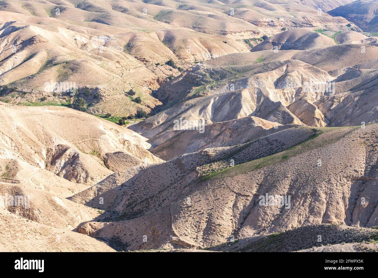 View of the slopes of the sandy mountains of the Judean Desert covered ...