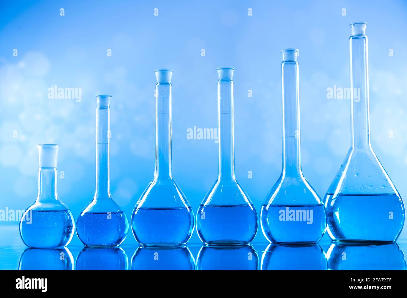 Laboratory beakers,Science experiment, blue background Stock Photo - Alamy