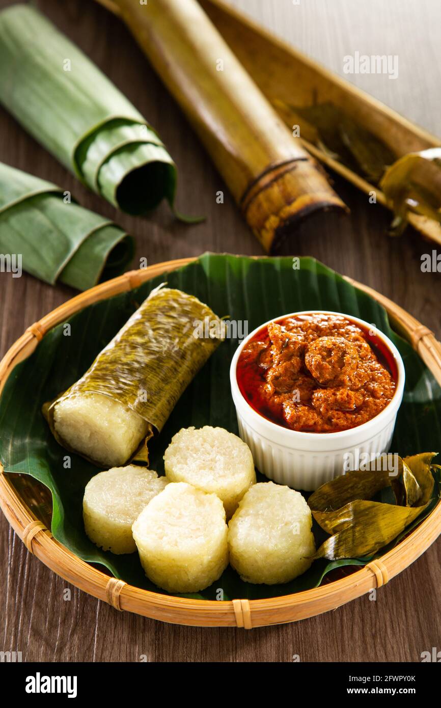Lemang. Glutinous rice is wrapped with lerek or banana leaf encased in ...