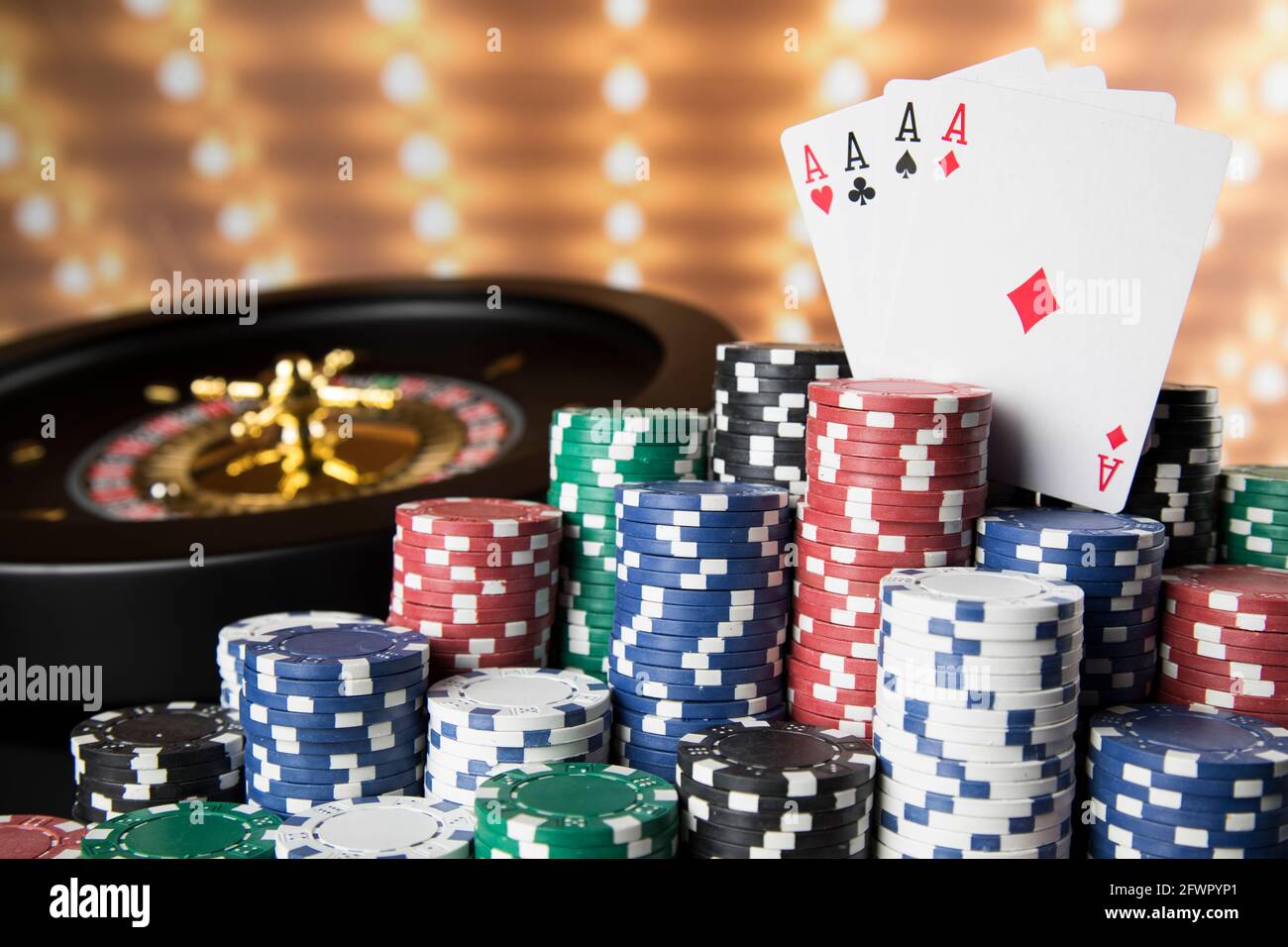 Poker Chips on gaming table, roulette wheel in motion, casino ...