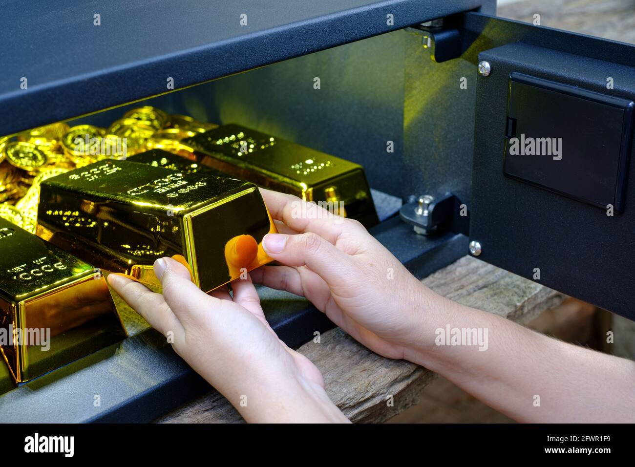 Hand open electronics steel safe box full of coins stack and gold ba ...