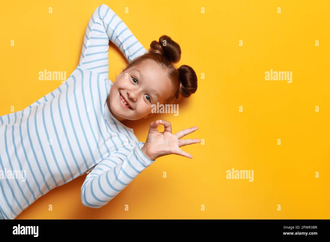 Top view of a cute adorable little girl with bundles of hair on a ...