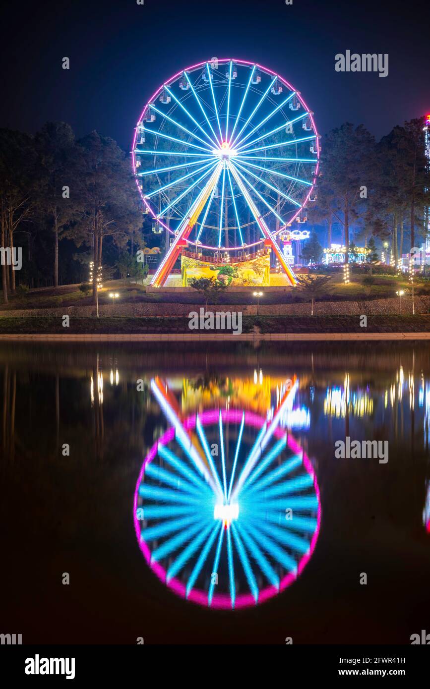 Spinning ferris wheel at night Stock Photo - Alamy