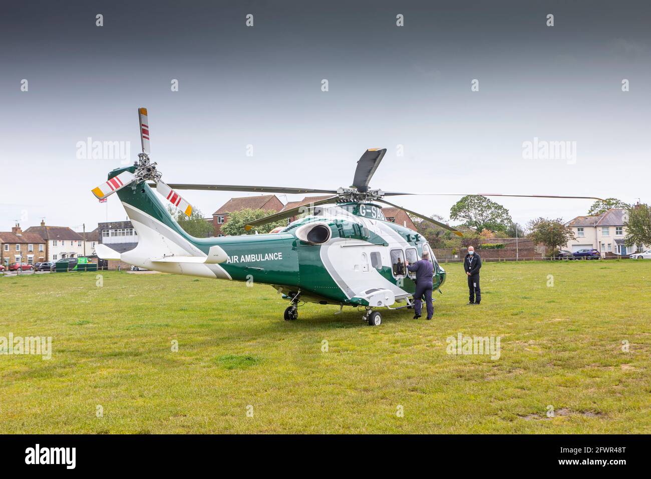 An Air Ambulance helicopter on Hythe Green, Kent Stock Photo - Alamy