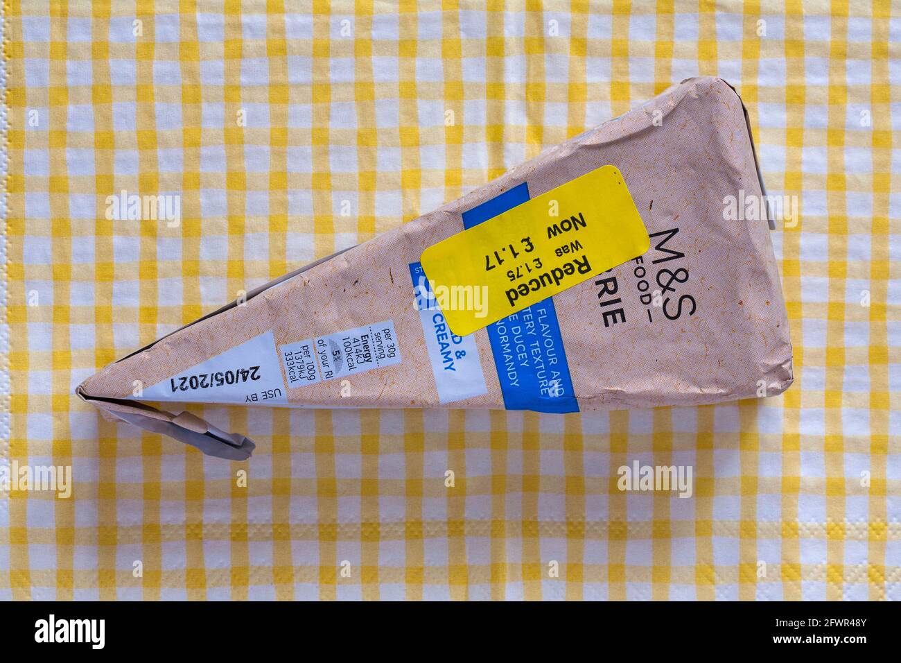 Pack of M&S Brie cheese reduced price sticker set on yellow and white ...