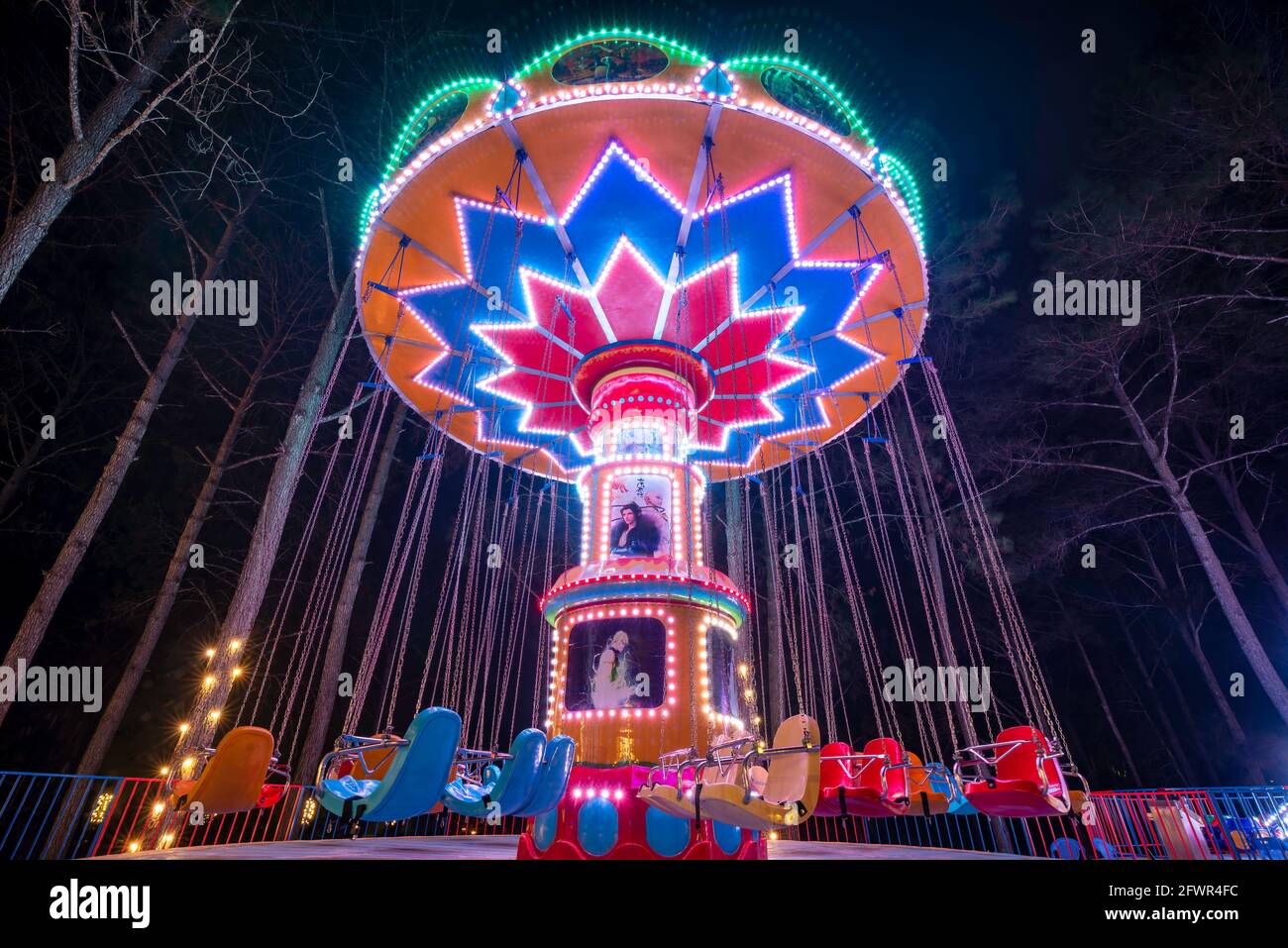 Swing ride at fair spinning around with people having fun Stock Photo ...
