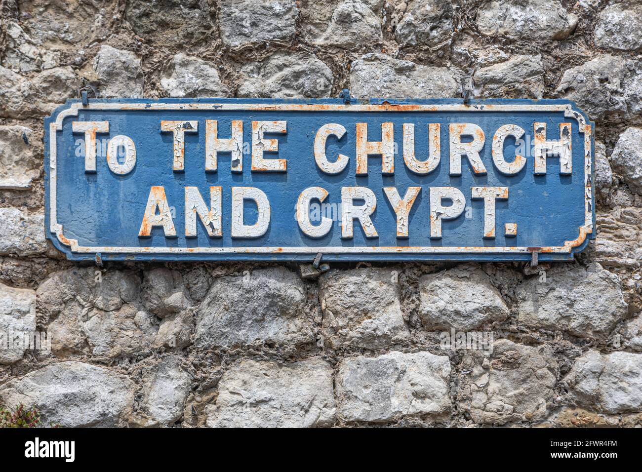 An old worn and cracked sign for a Church and crypt Stock Photo - Alamy