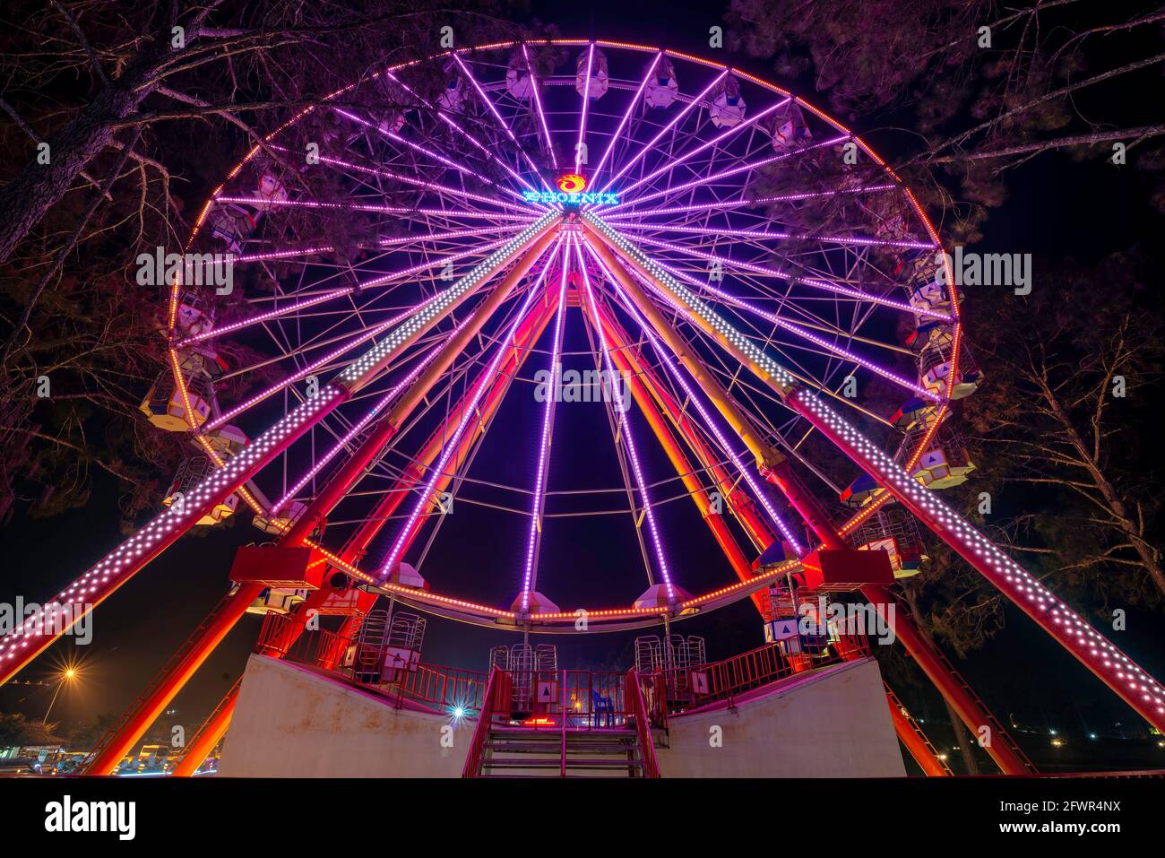 Spinning ferris wheel at night Stock Photo - Alamy