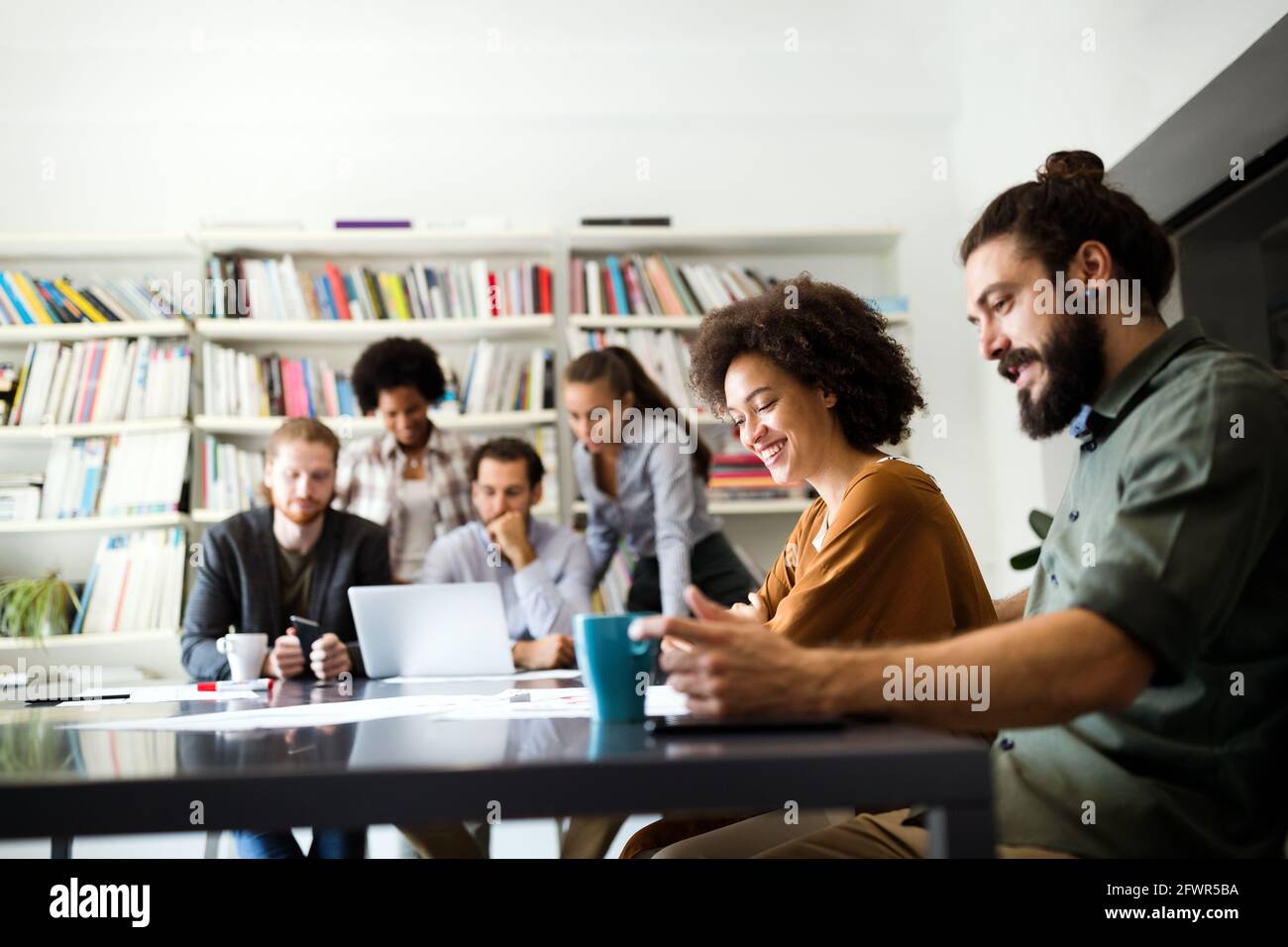 Programmers cooperating brainstorming at information technology company ...