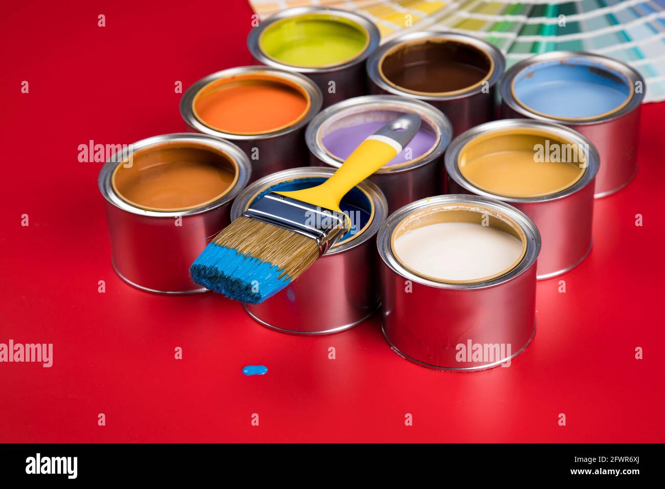 Paint brush, tin can and color guide samples Stock Photo - Alamy