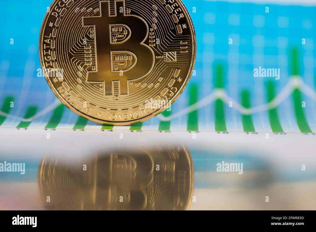 Gold Bitcoin on the background of the chart Stock Photo - Alamy
