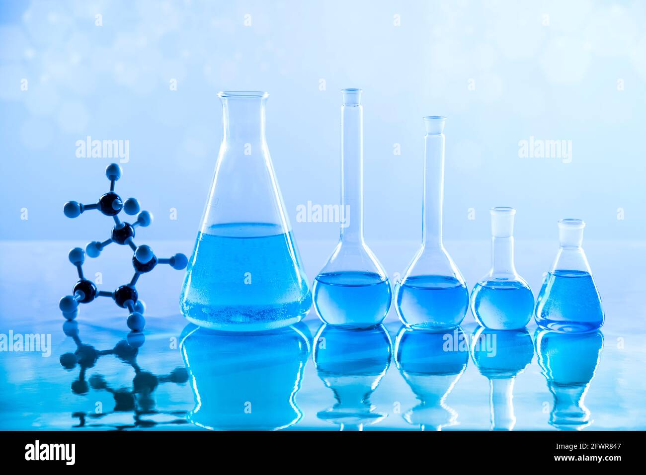 Laboratory beakers,Science experiment, blue background Stock Photo - Alamy
