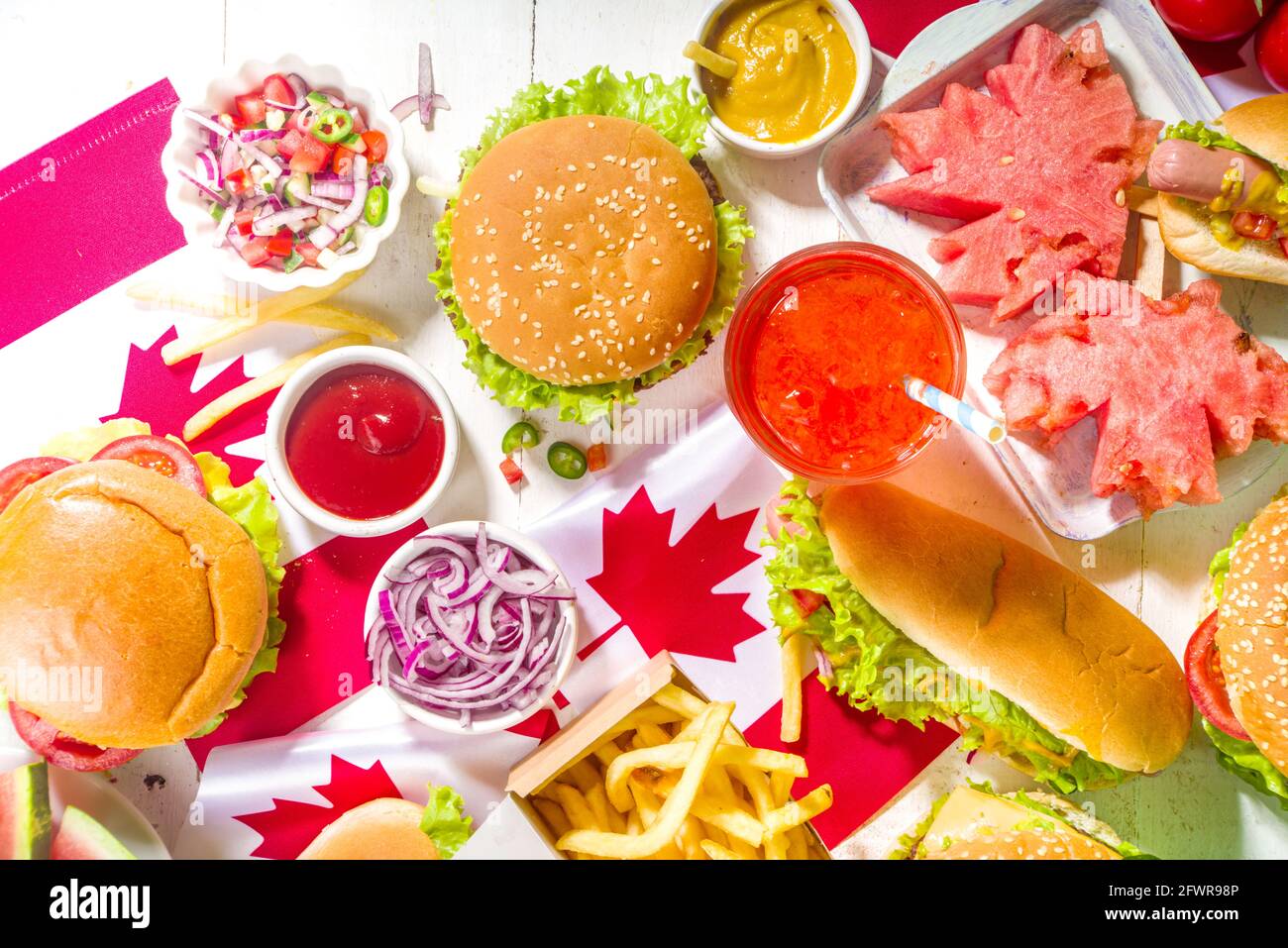 Set of various Canada Day bbq food. Picnic party table with maple leaf ...