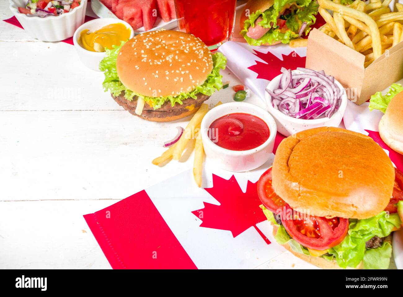 Set of various Canada Day bbq food. Picnic party table with maple leaf ...