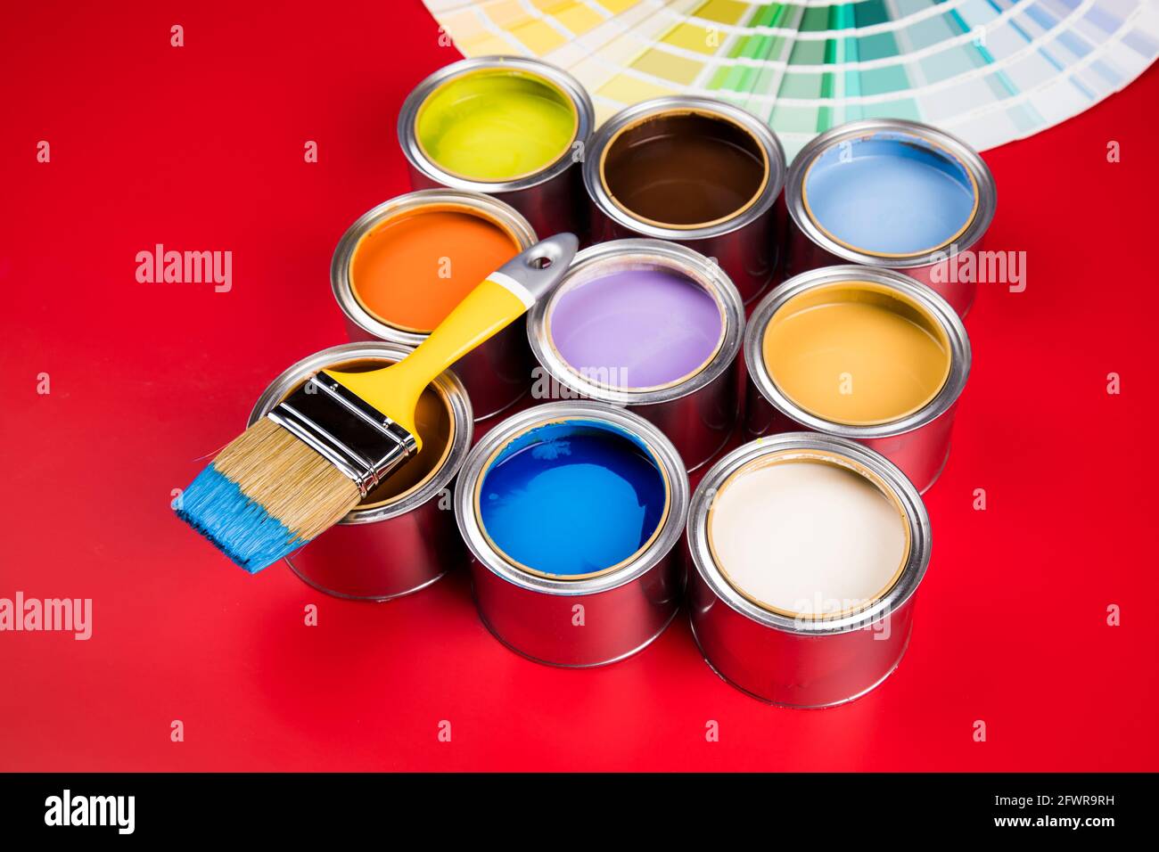 Paint brush, tin can and color guide samples Stock Photo - Alamy