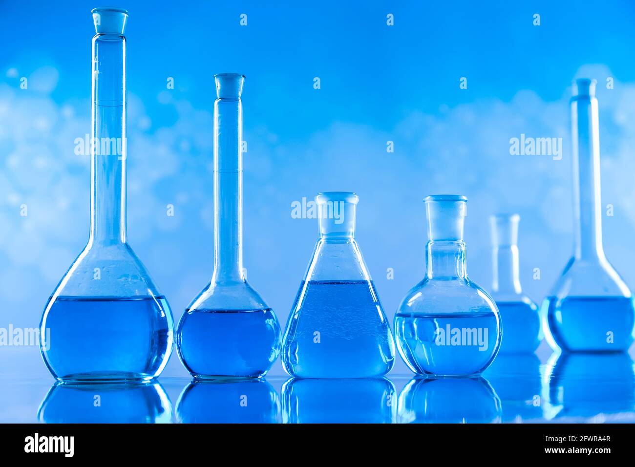 Laboratory beakers,Science experiment, blue background Stock Photo - Alamy