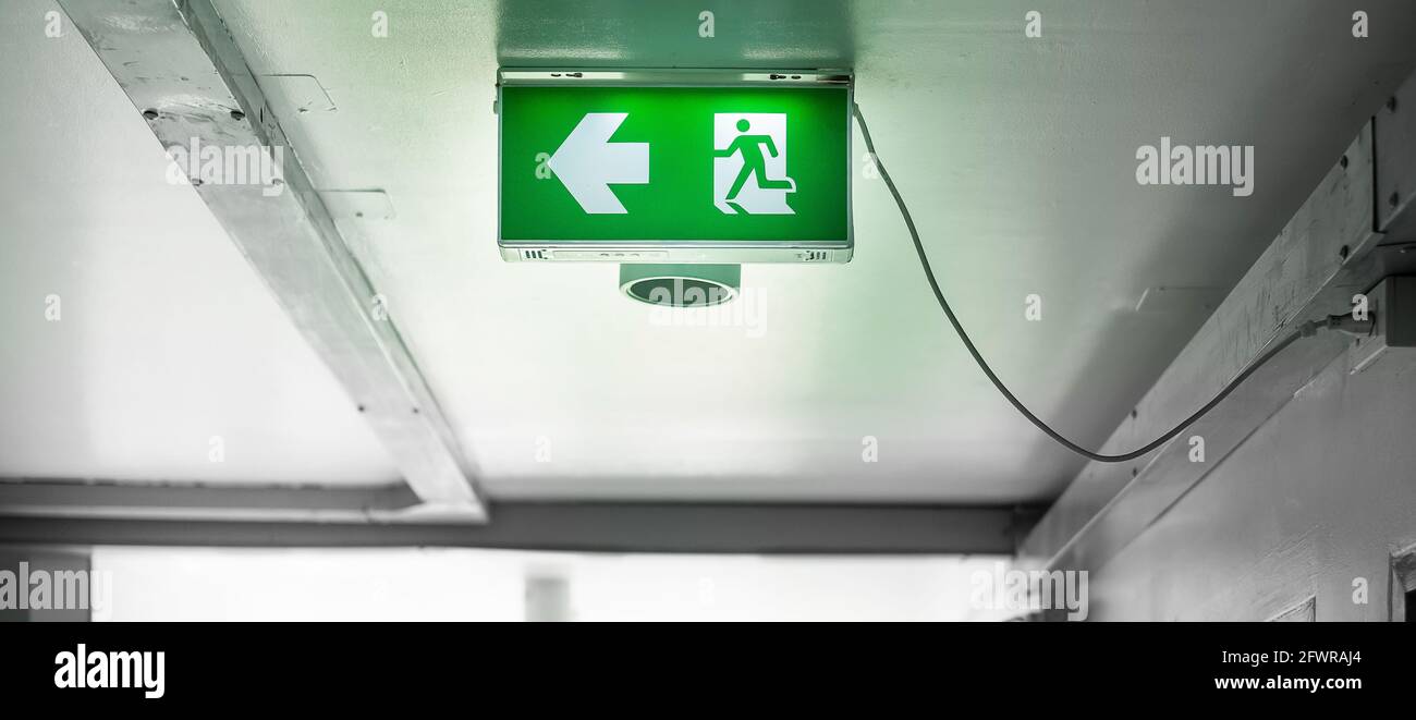 Fire Emergency exit sign on the wall background inside building. Safety ...