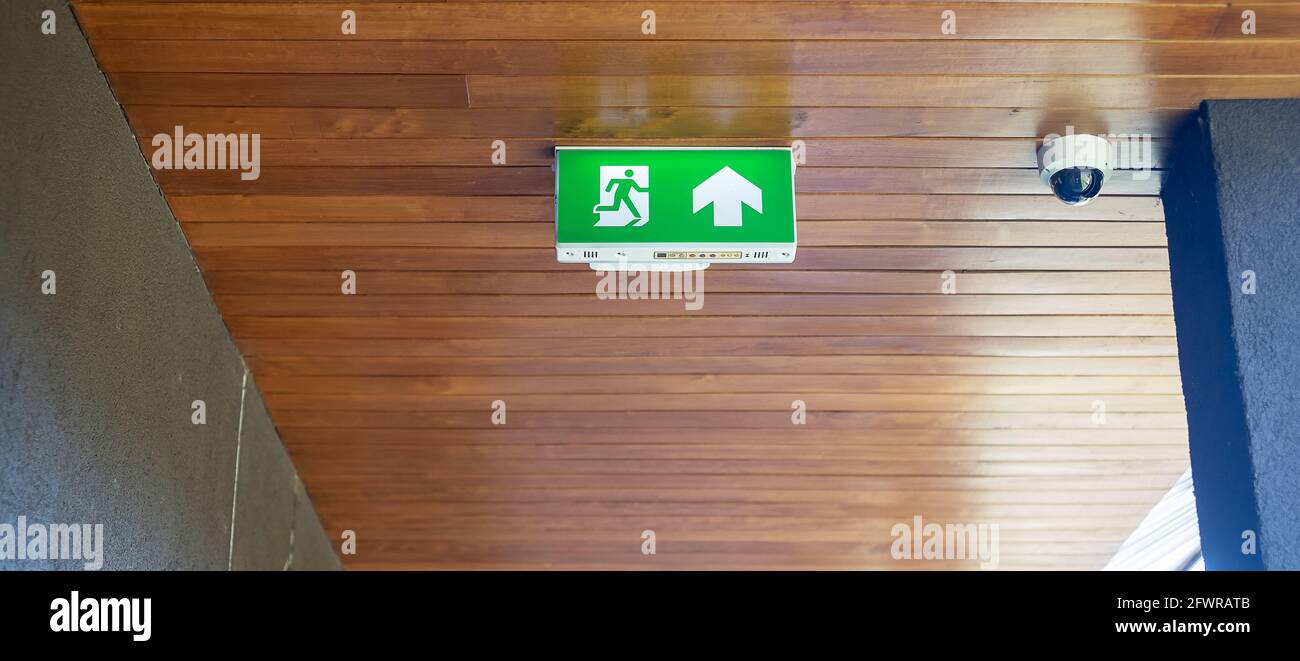 Fire Emergency exit sign on the wall background inside building. Safety ...