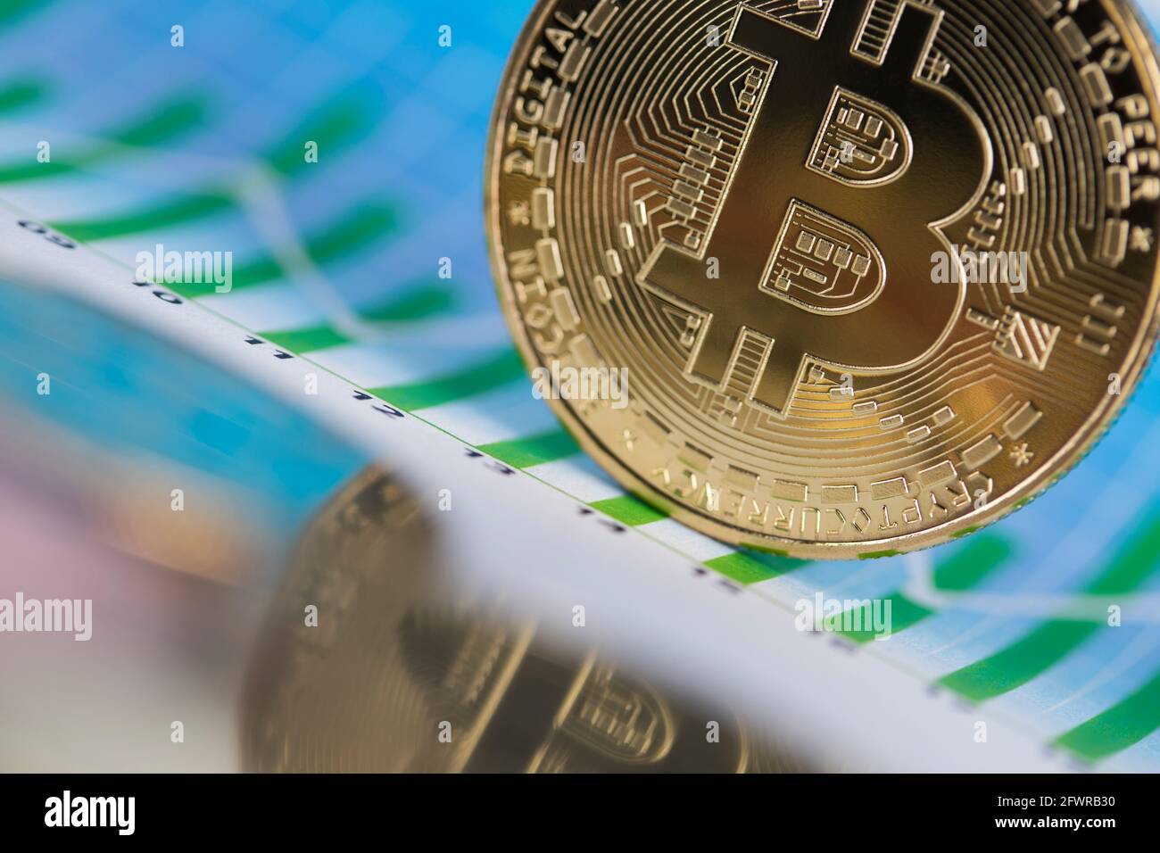 Gold Bitcoin on the background of the chart Stock Photo - Alamy
