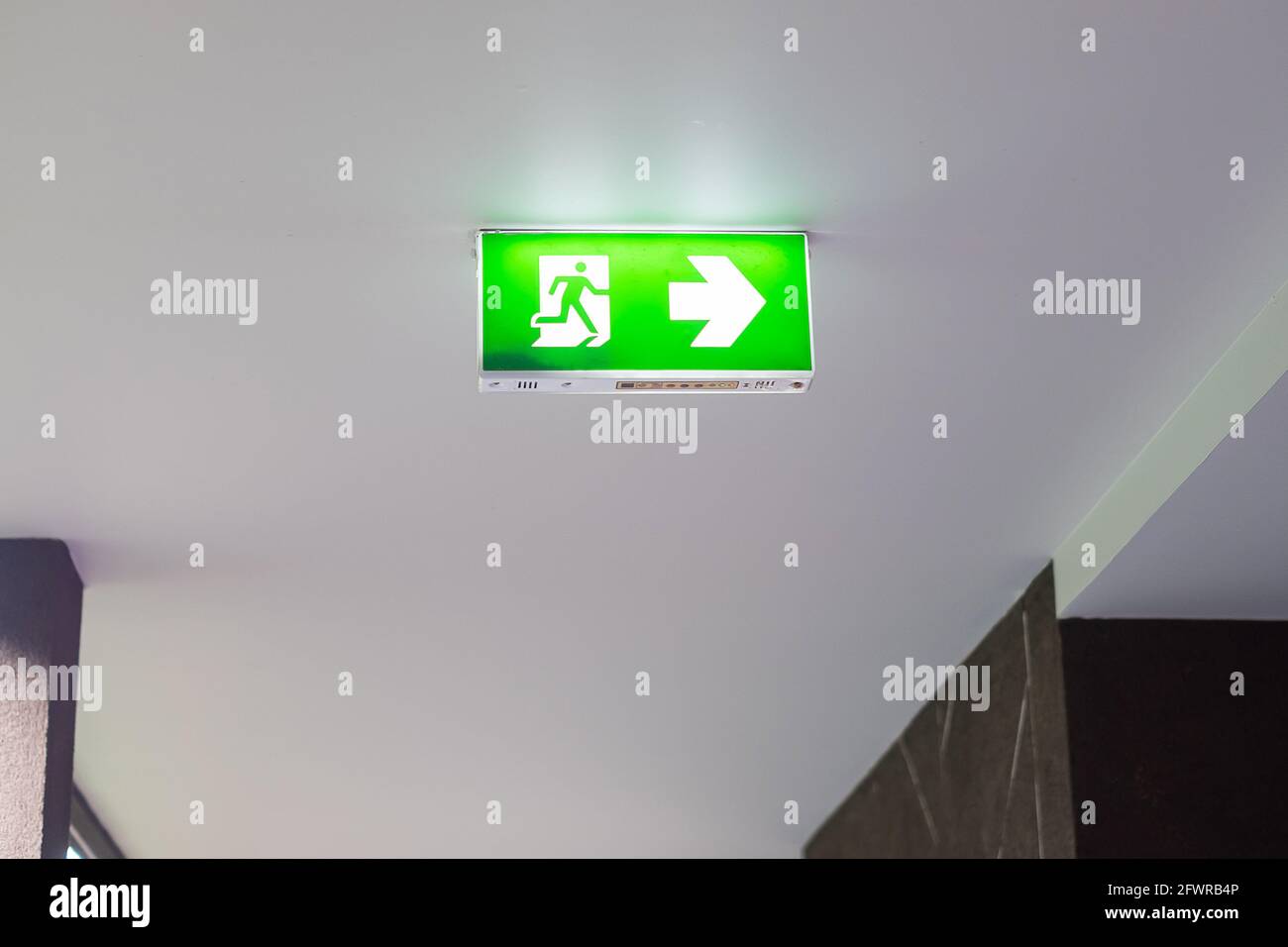 Fire Emergency exit sign on the wall background inside building. Safety ...