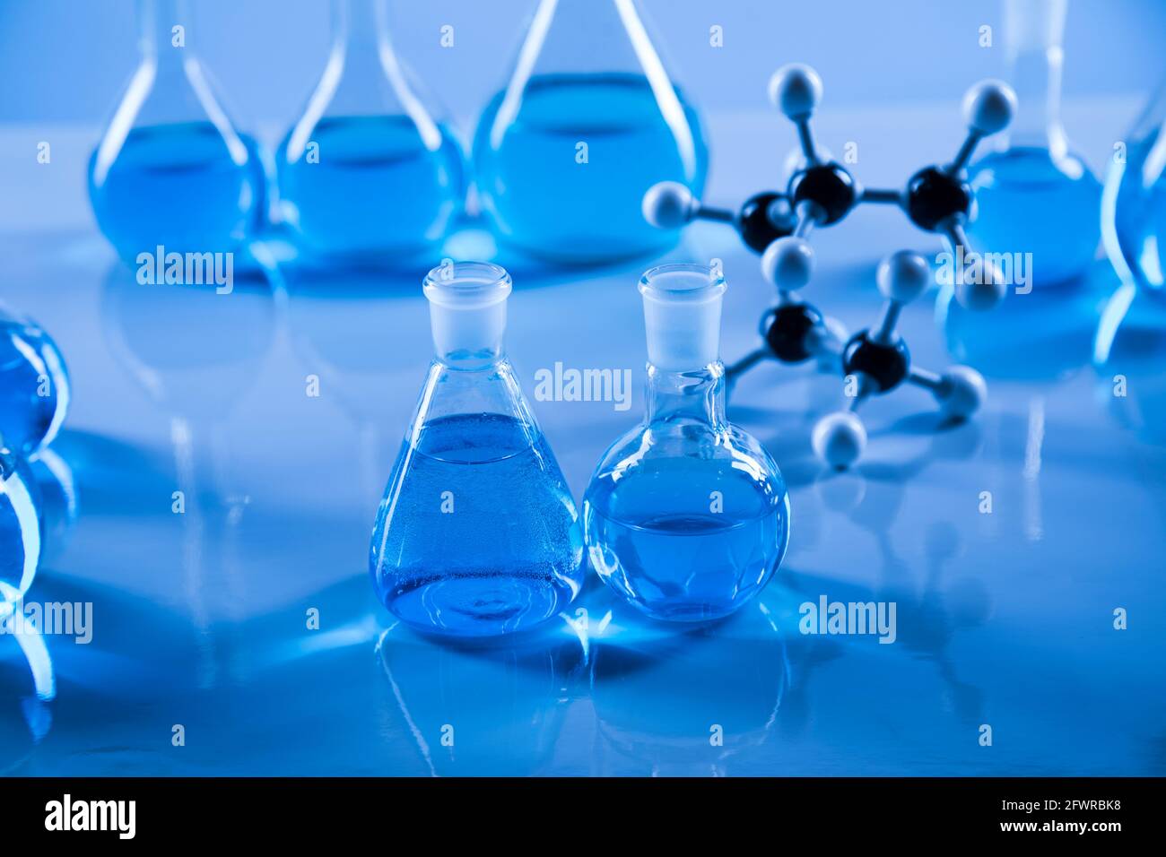 Laboratory beakers,Science experiment, blue background Stock Photo - Alamy