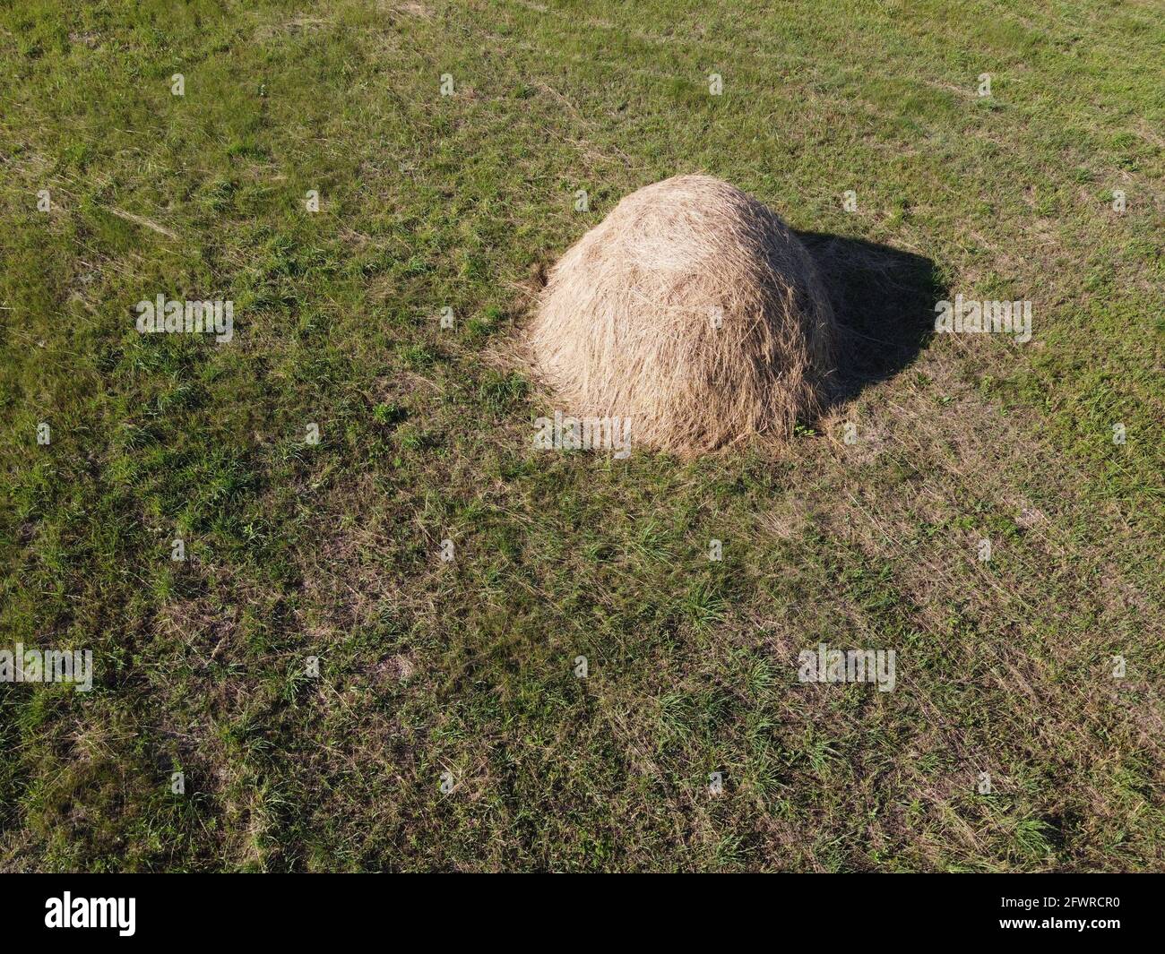 Haystack in a farm field on a warm summer day, top view. Landscape from ...