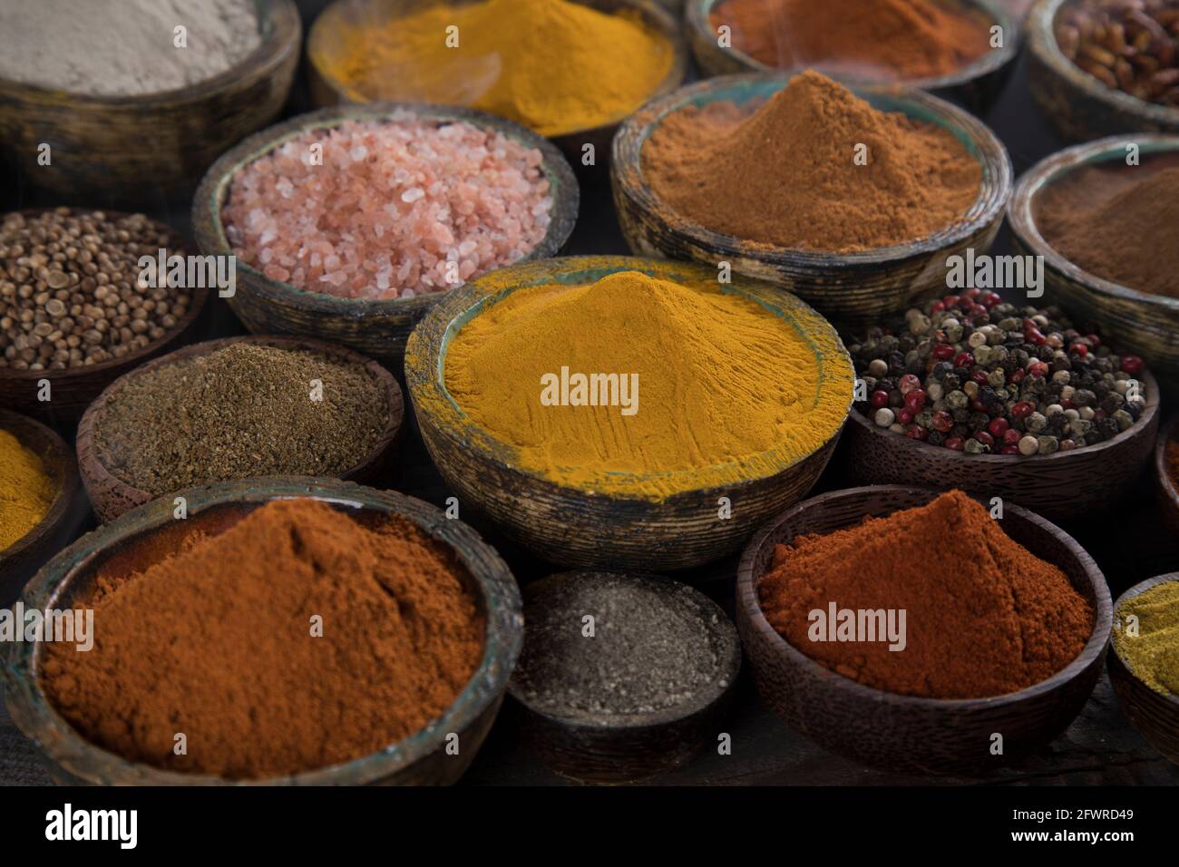 Wooden table of colorful spices Stock Photo - Alamy