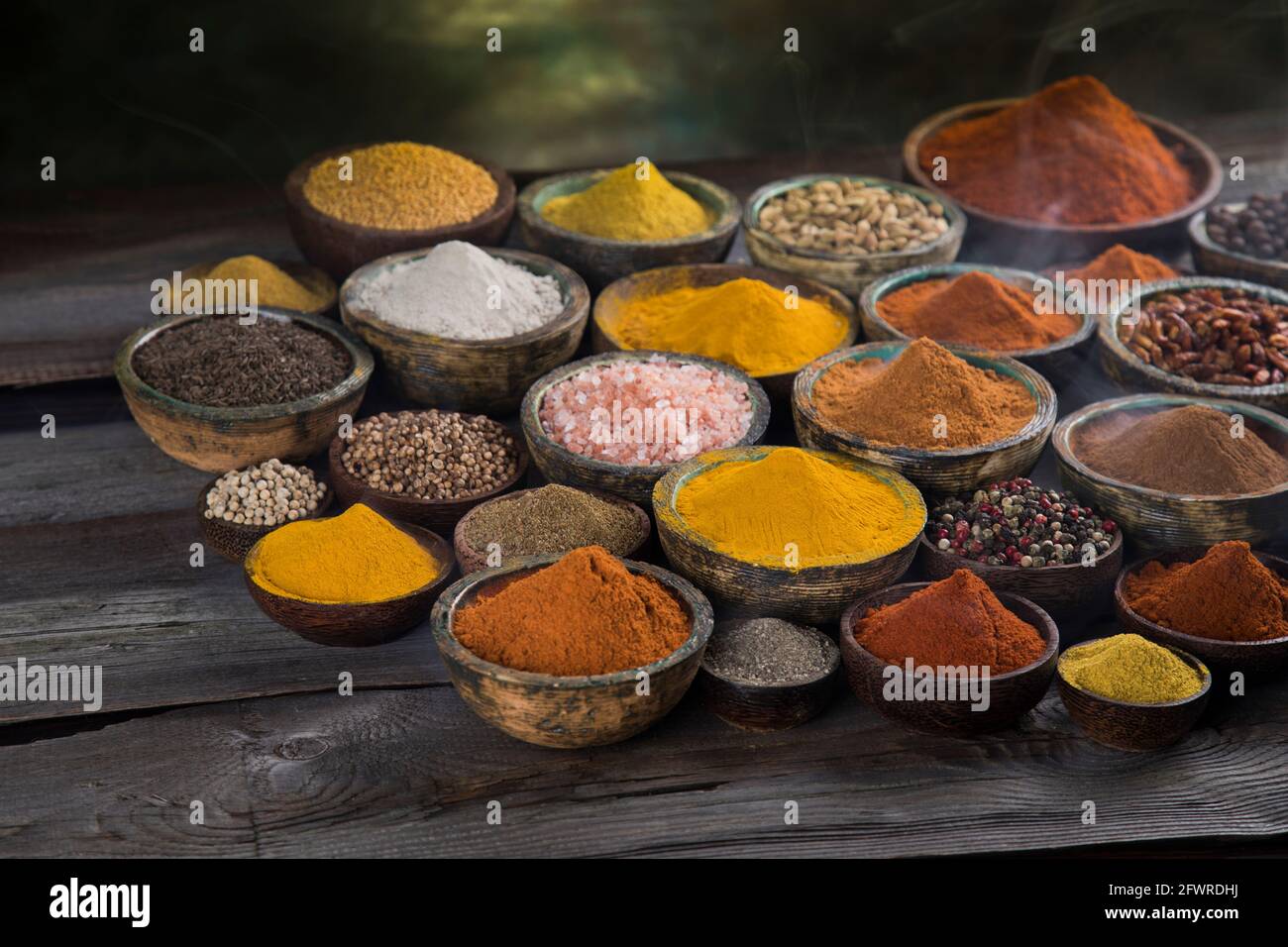 Wooden table of colorful spices Stock Photo - Alamy