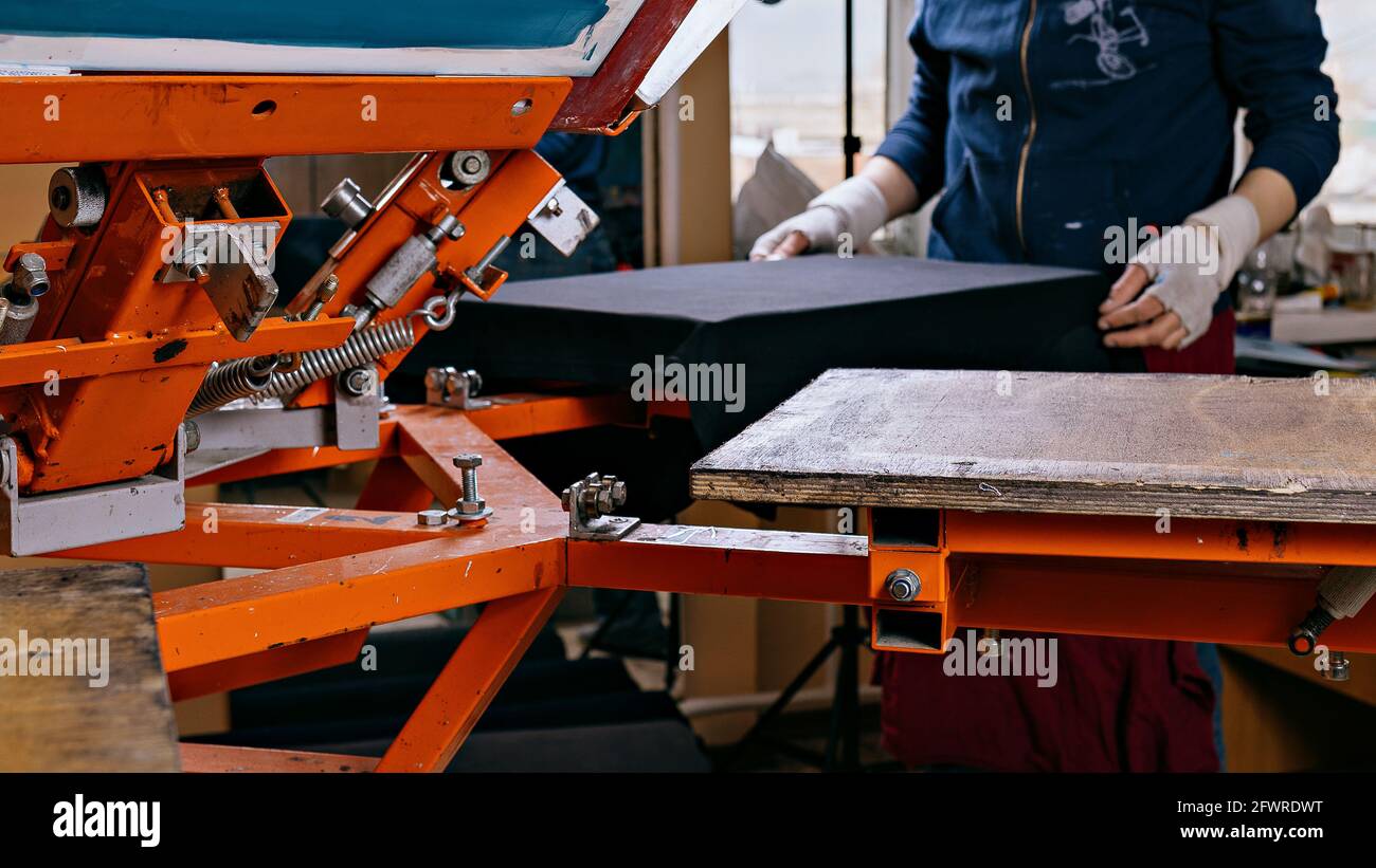 selective focus photo of print screening apparatus and worker ...